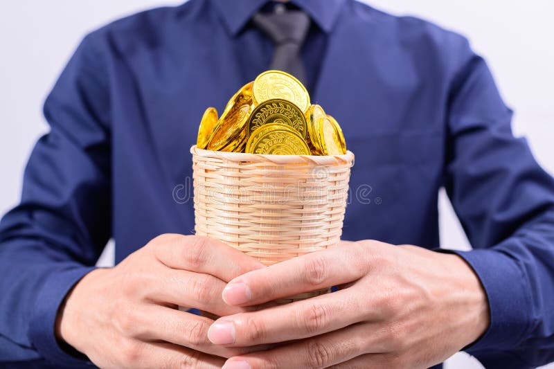 Businessman Holding a Basket Full of Money on a Gray Background Stock ...