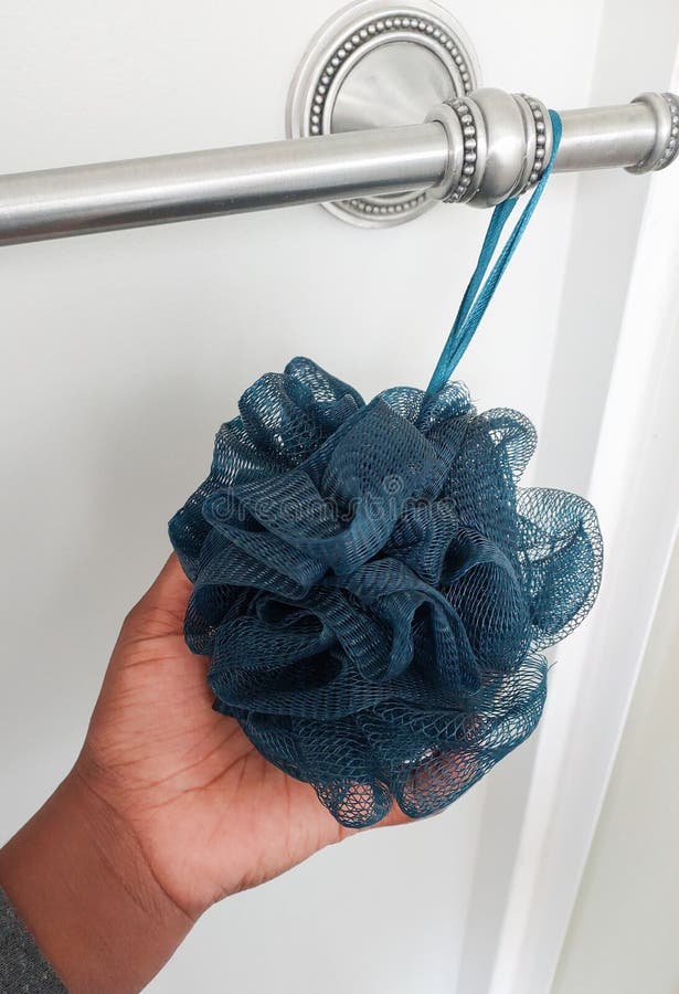 Hand holding a bath sponge stock photo. Image of bathing - 285887156