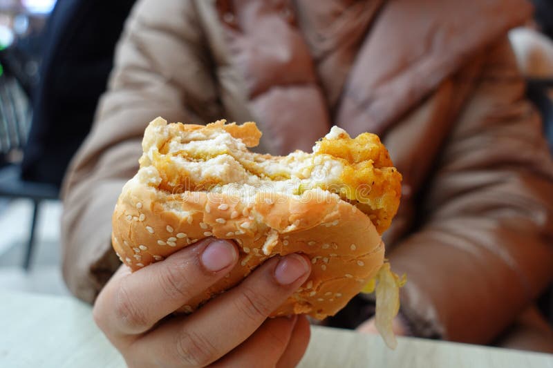 Hand Holding Beef Burger on Table Close Up Stock Photo - Image of ...