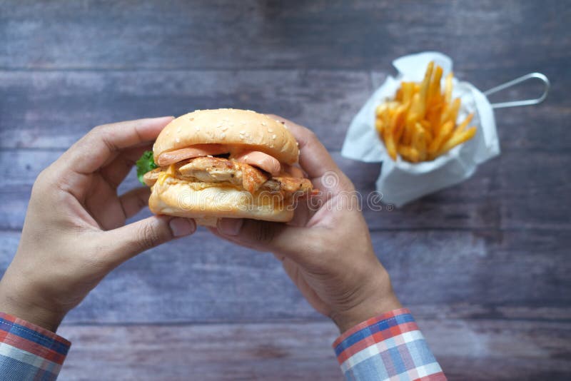 Hand Holding Beef Burger on Table Top Down Stock Image - Image of food ...