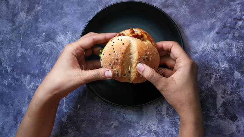 Hand Holding Beef Burger on Table Top View Stock Video - Video of ...