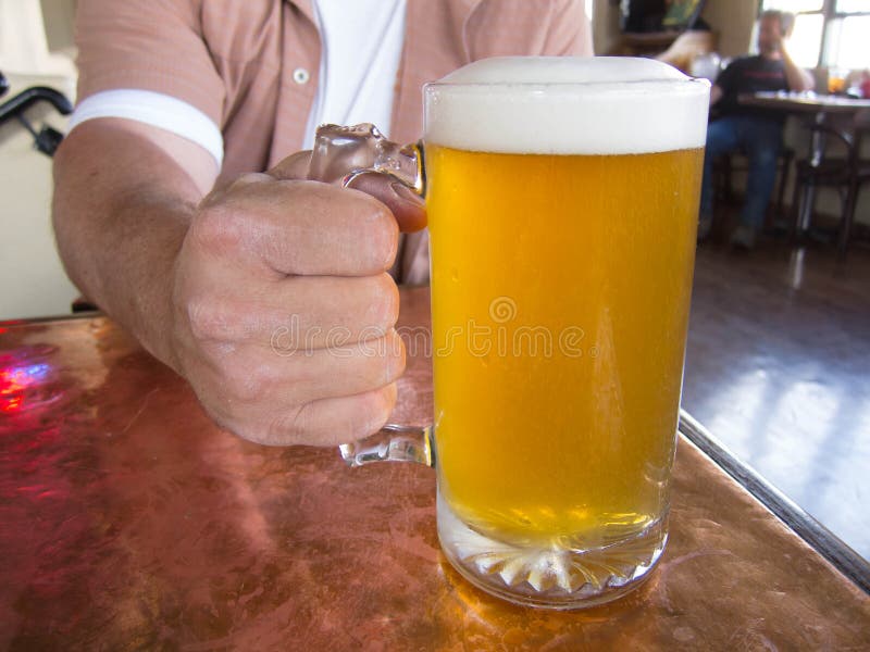 Hand holding beer stock image. Image of drinking, indoor - 31048401
