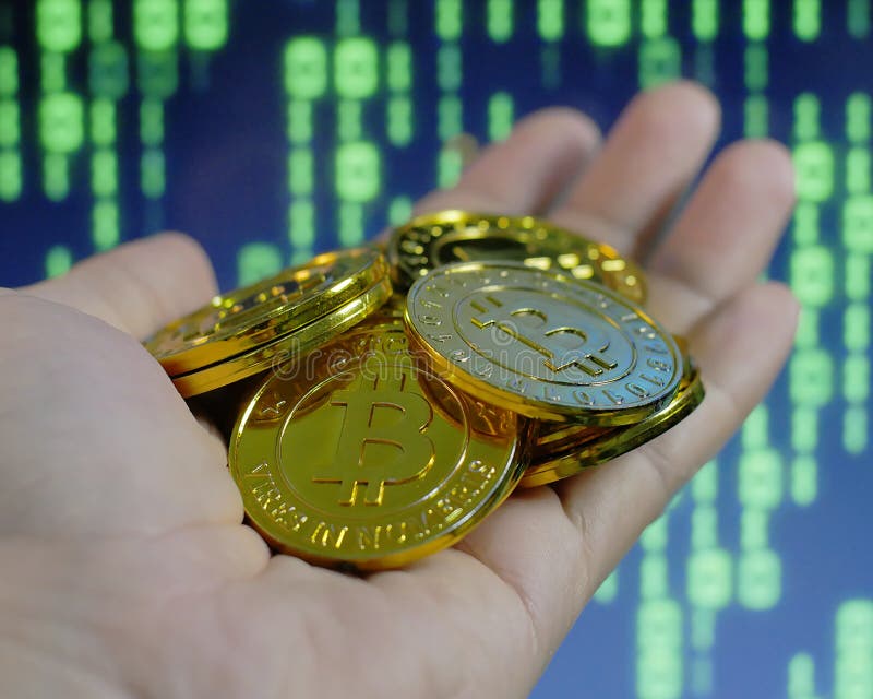 Hand Holding Bitcoins stock photo. Image of currency - 210373548