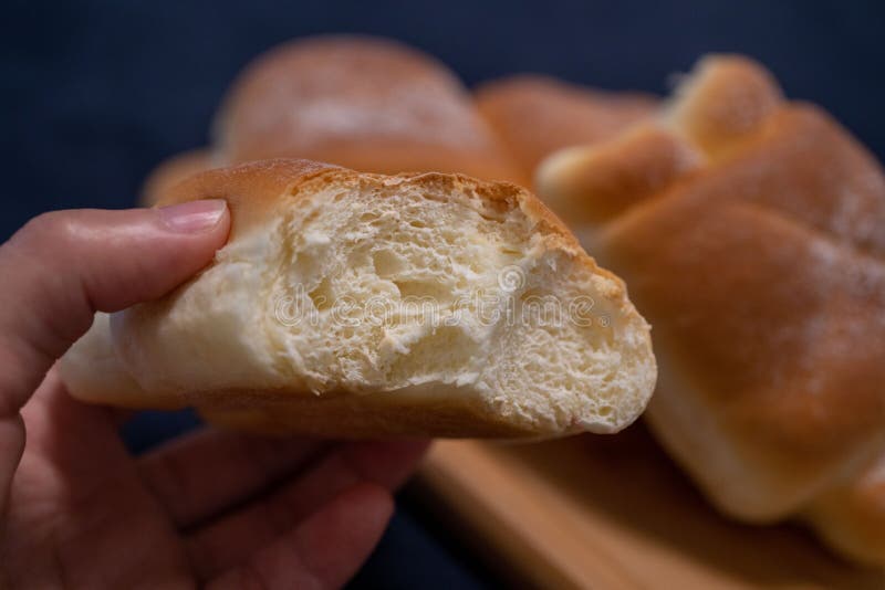 The Hand is Holding a Bitten Bread. Stock Image - Image of indoor ...