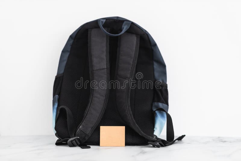 Hand Holding Blank Message Label in Front of Backpack, Concept of ...