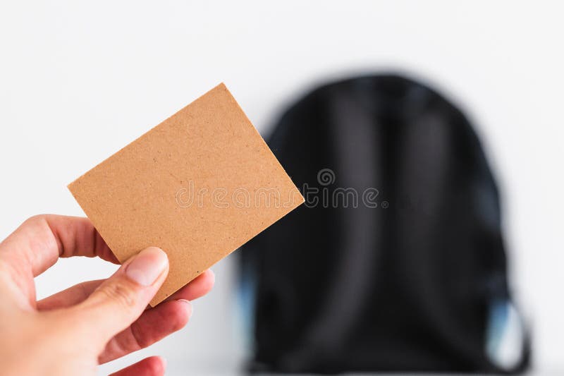 Hand Holding Blank Message Label in Front of Backpack, Concept of ...