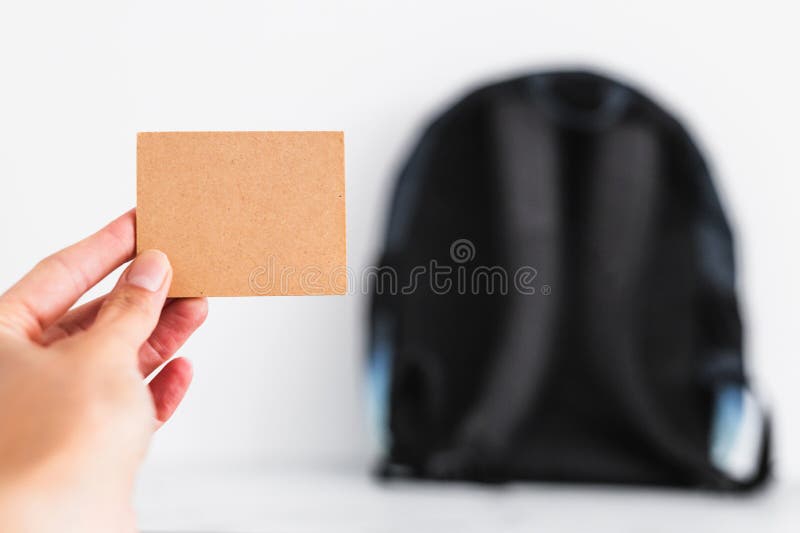 Hand Holding Blank Message Label in Front of Backpack, Concept of ...