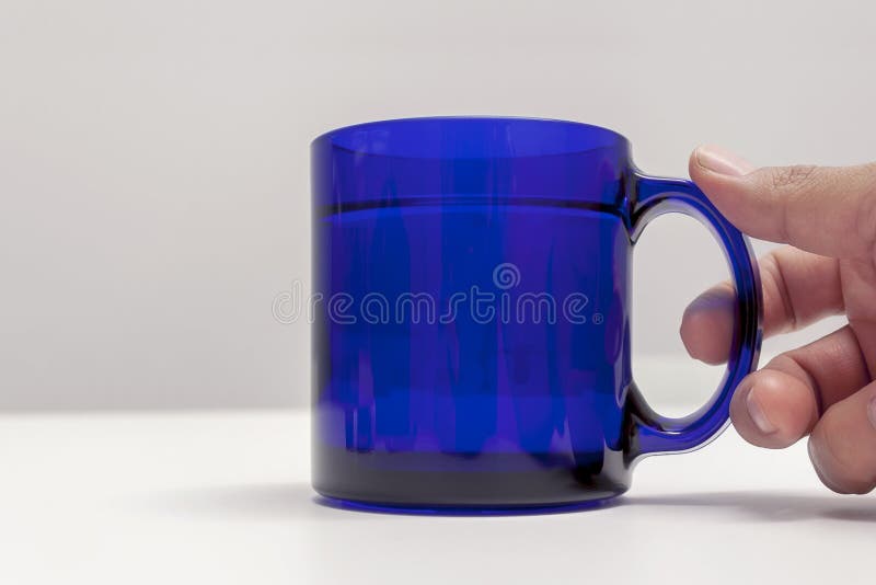 Hand Holding a Blue Cup of Tea Stock Photo - Image of ceramic, hand ...
