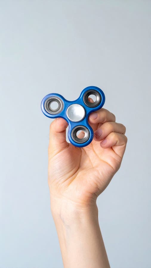 Hand Holding a Blue Fidget Spinner Toy for Relaxation on White ...