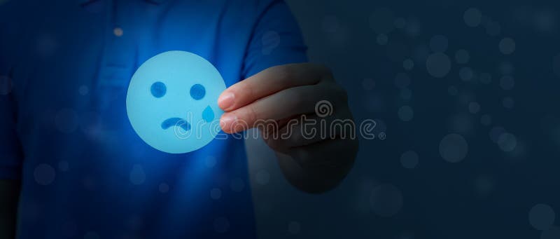 Hand Holding a Blue Sad Face Sign - the Blue Monday Concept Stock Photo ...