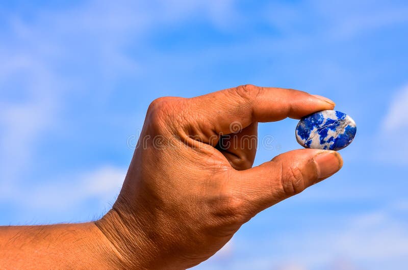 A Hand Holding a Blue and White Stone Stock Photo - Image of color ...