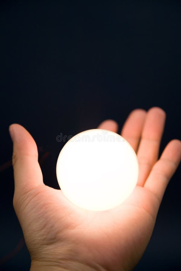 Hand holding a bright ball stock image. Image of magic - 10064581