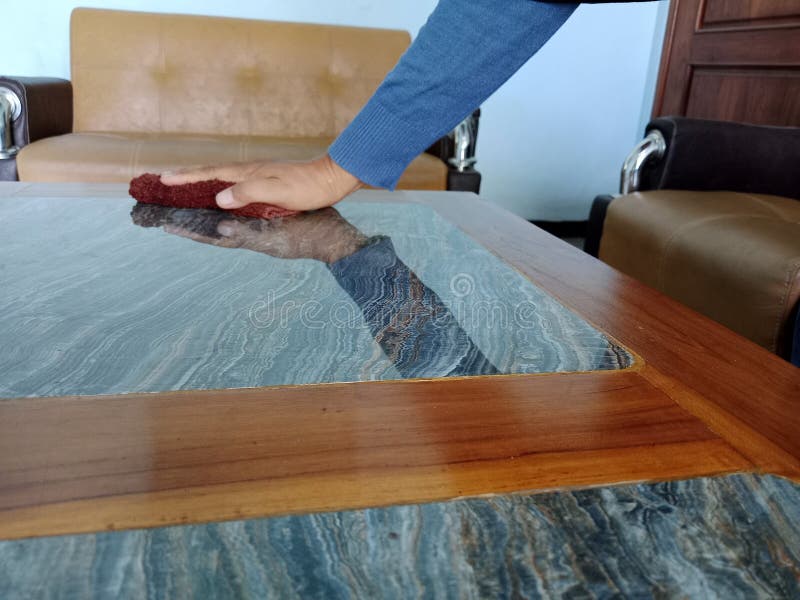 The Hand Holding the Brown Rag Wipes the Ceramic Table Stock Photo ...