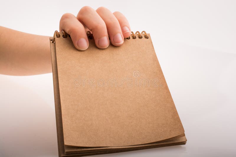 Hand holding a notebook stock image. Image of memo, notebook - 124619213