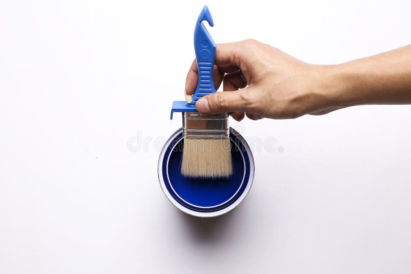 Hand Holding a Brush Put in a Can of Blue Paint Stock Image - Image of ...
