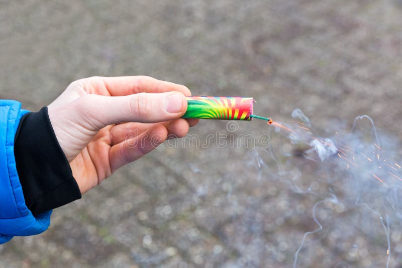 Hand Holding Burning Firework in Street Stock Photo - Image of flour ...