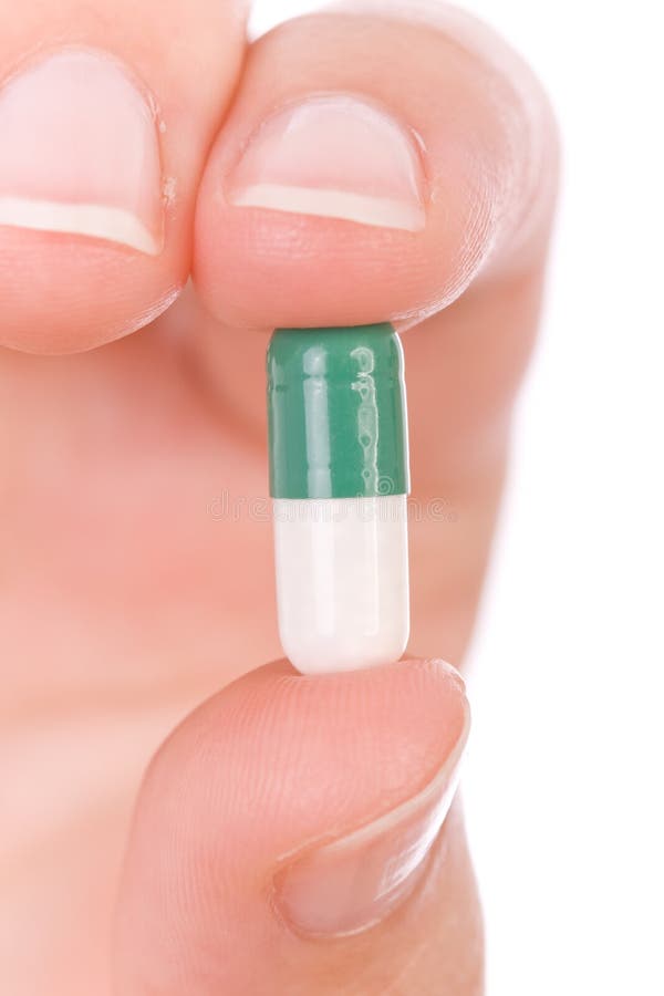 Hand Holding a Capsule or Pill Stock Photo - Image of holding, capsule ...