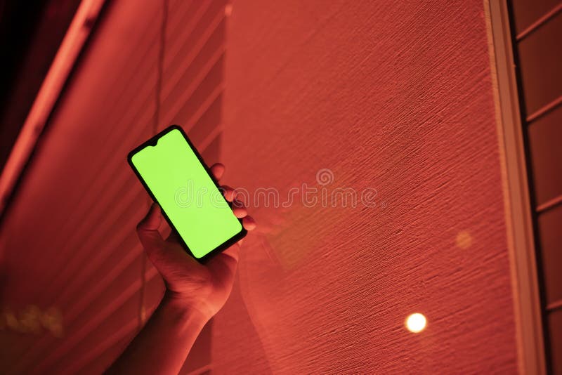 Hand Holding a Cell Phone with the Screen on Camera in the City at ...