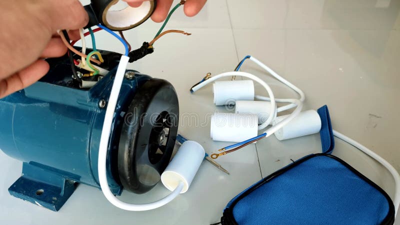 Hand Holding and Checking Electric Motor Capacitor or Single Phase ...