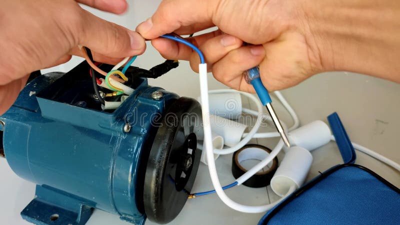 Hand Holding and Checking Electric Motor Capacitor or Single Phase ...