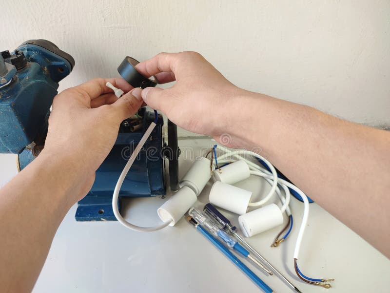 Hand Holding and Checking Electric Motor Capacitor or Single Phase ...