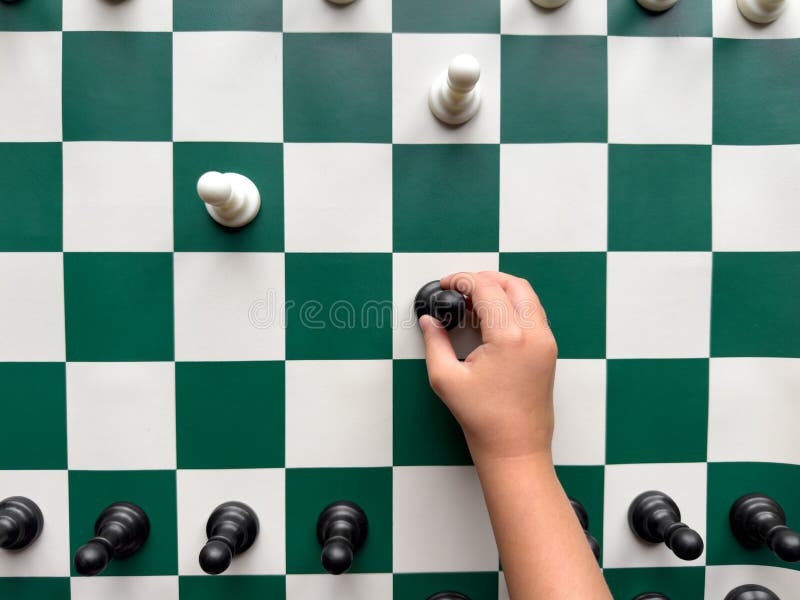 Hand Holding Chess Piece on Vertical Chessboard with Green and White ...