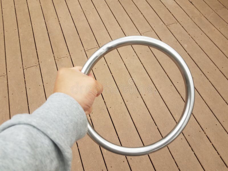 Hand Holding Circular Metal Ring and Wood Floor Stock Image - Image of ...
