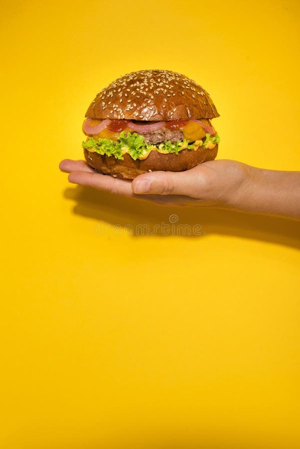 Hand Holding Classic Beef Burger with Lettuce. High Quality Photo Stock ...