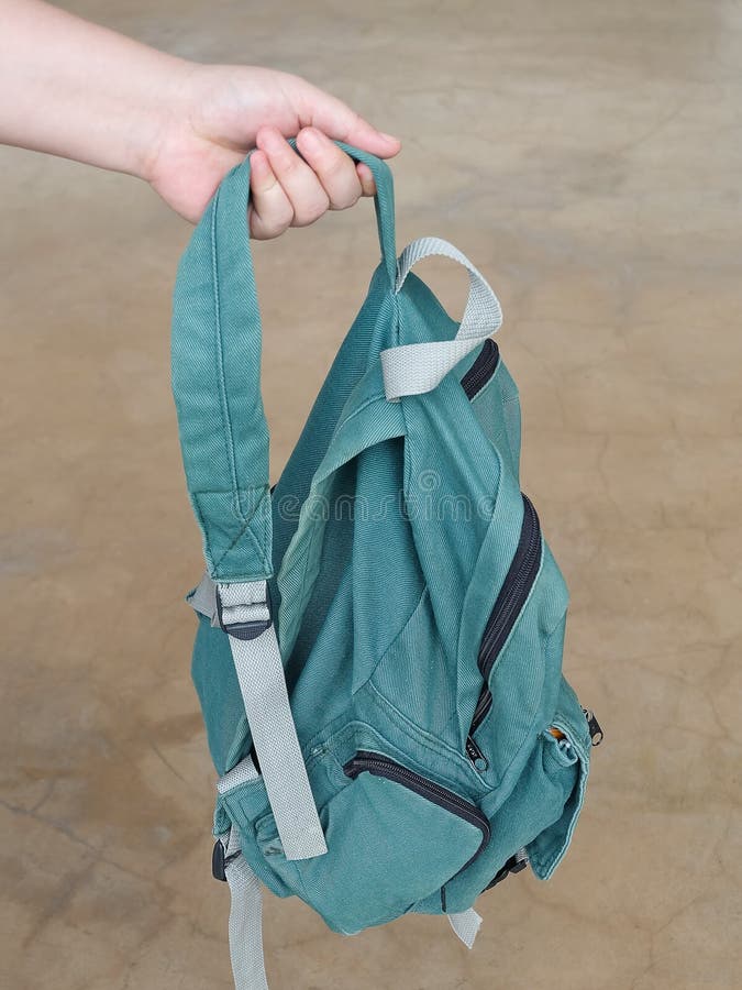 Hand Holding a Classic Green Fabric Backpack Stock Image - Image of ...