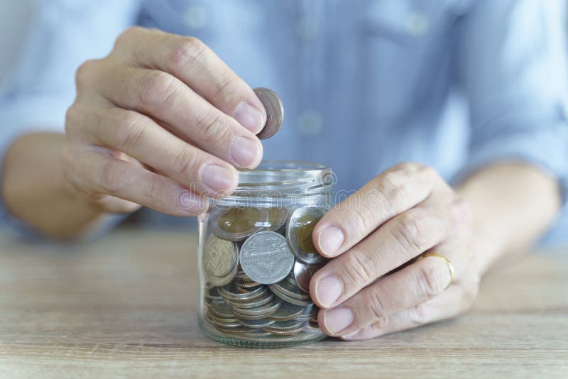 Hand Holding a Coin, Ideas for Saving Money Concept. Money Management ...