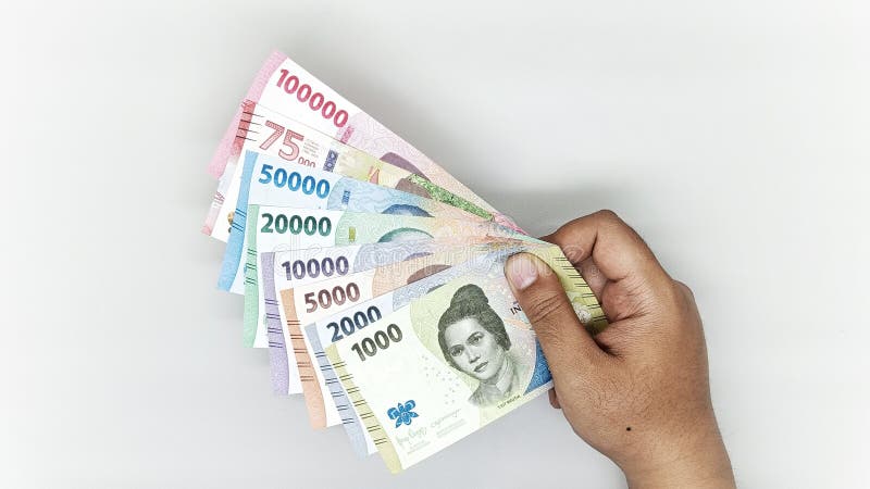 Hand Holding a Collection of Indonesian Banknotes Stock Photo - Image ...