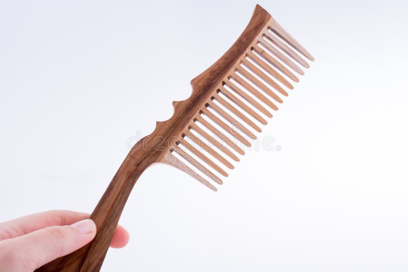 405 Hand Holding Wooden Comb Background Stock Photos - Free & Royalty ...