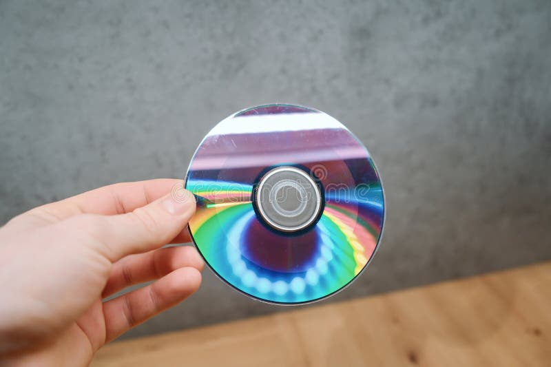 Hand Holding a Compact Disc with Rainbow Reflection Stock Image - Image ...
