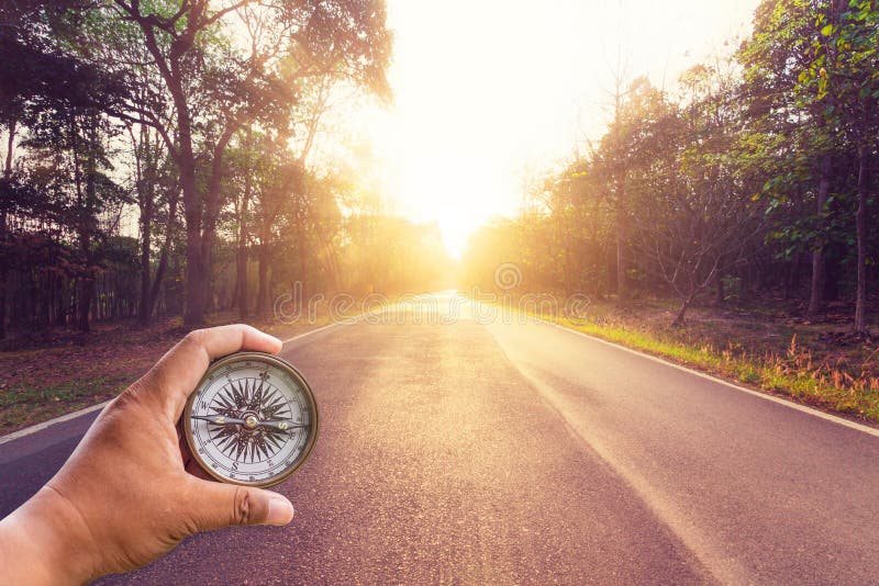 Hand Holding Compass on Empty Asphalt Road Stock Photo - Image of ...