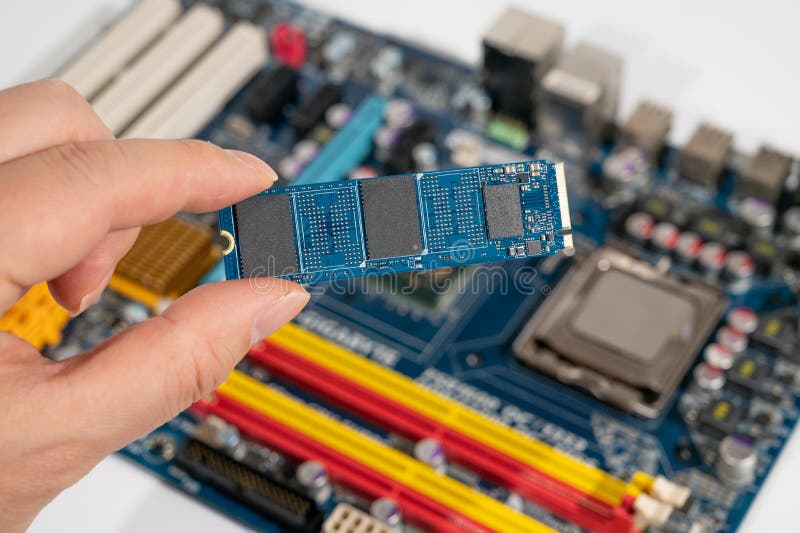The Hand Holding the Computer`s Mainboard and M.2 Solid State Drive ...