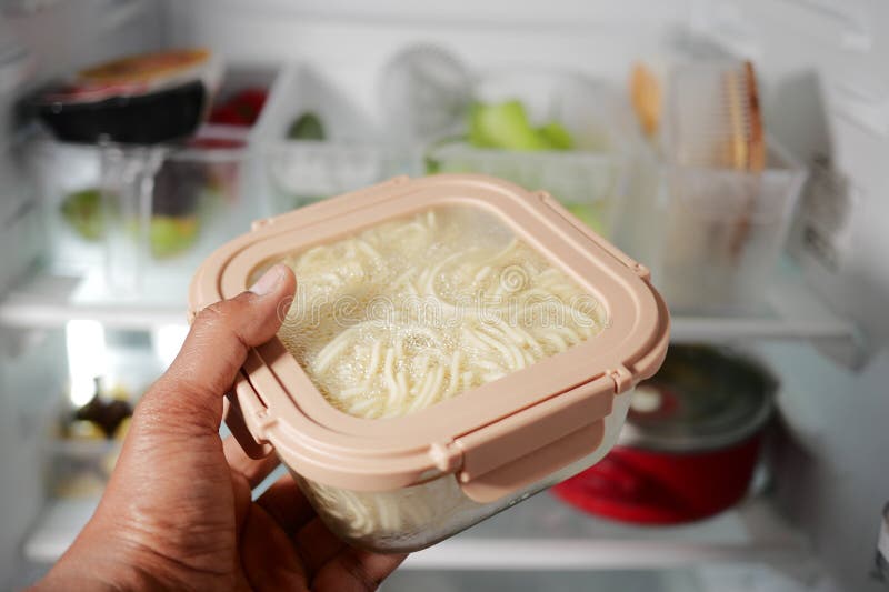 Hand Holding Container of Noodles Inside a Refrigerator Stock Image ...