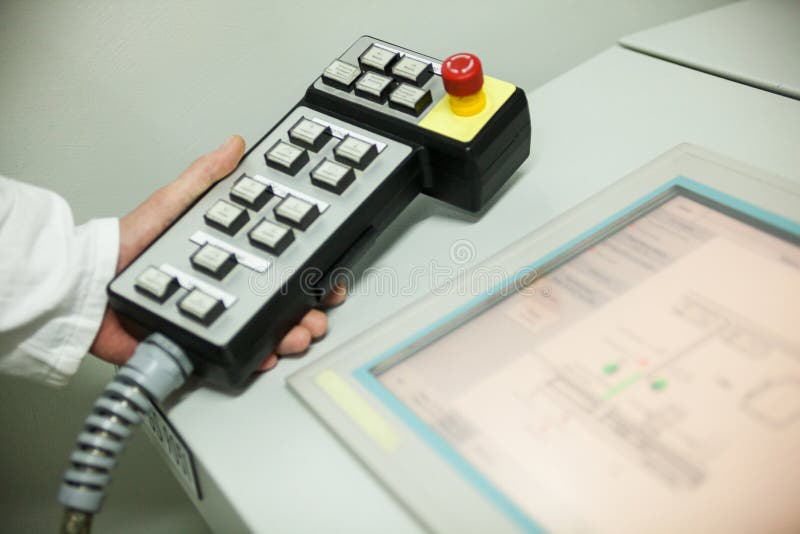 Hand Holding the Control Panel Stock Photo - Image of desk, plant ...