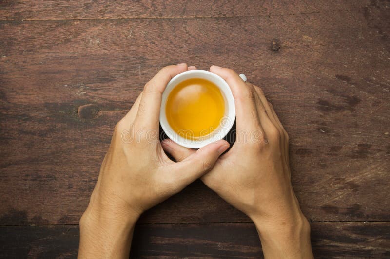 Hand holding cup of tea stock image. Image of drinking - 55669469