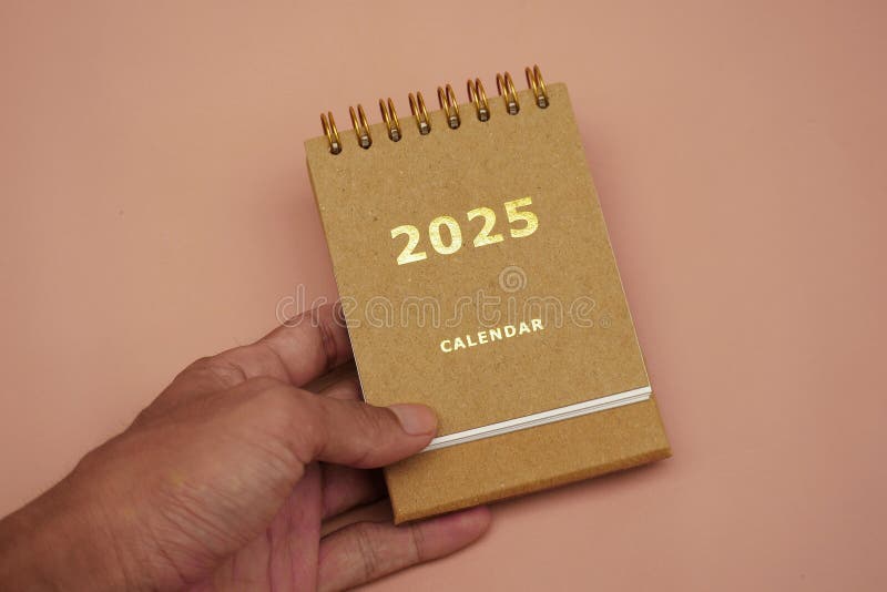 A Hand Holding a Desk Calendar for 2025 Stock Photo - Image of annual ...