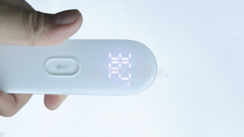 A Hand Holding Digital Thermometer Showing Normal Temperature With On