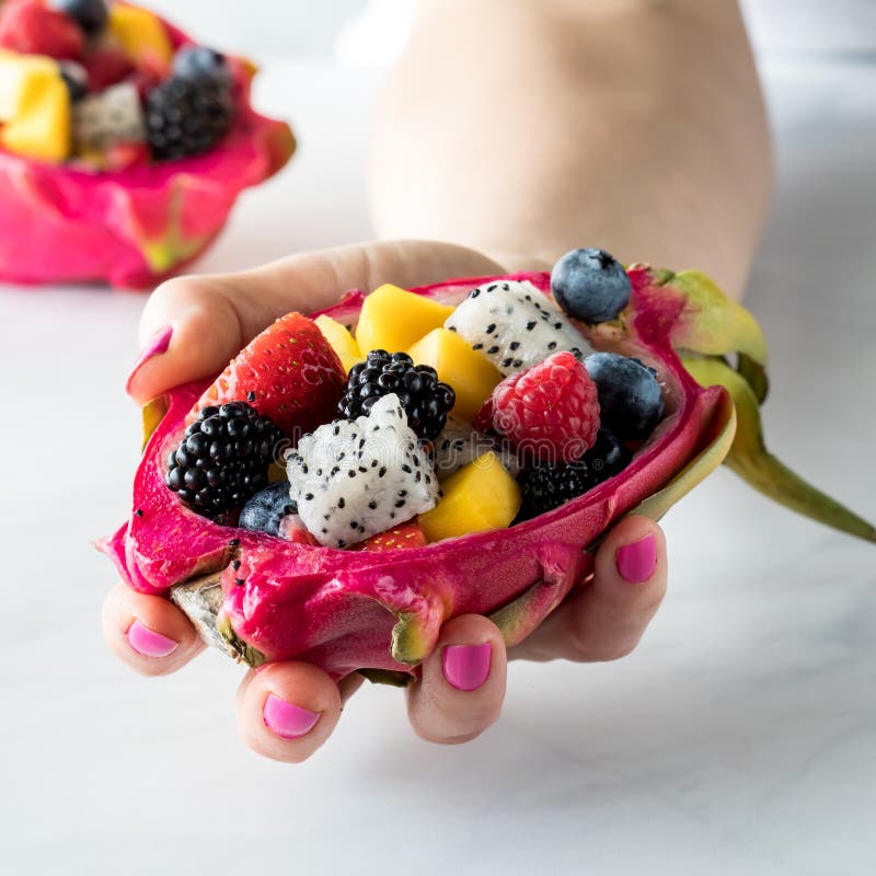A Hand Holding a Dragon Fruit Shell Filled with a Fresh Fruit Salad ...
