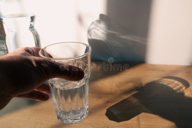 Hand Holding Drinking Water Bottle Pouring into Glass. Hand Pouring ...