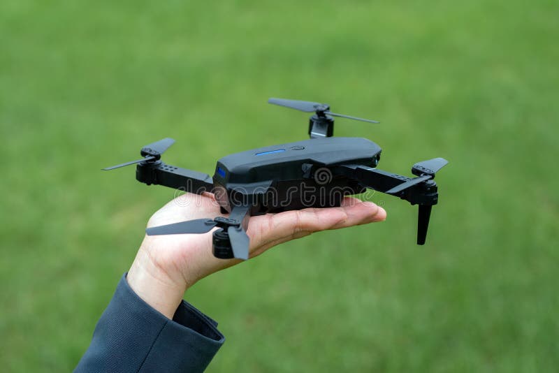A Hand Holding a Drone in the Palm Stock Photo - Image of grass ...