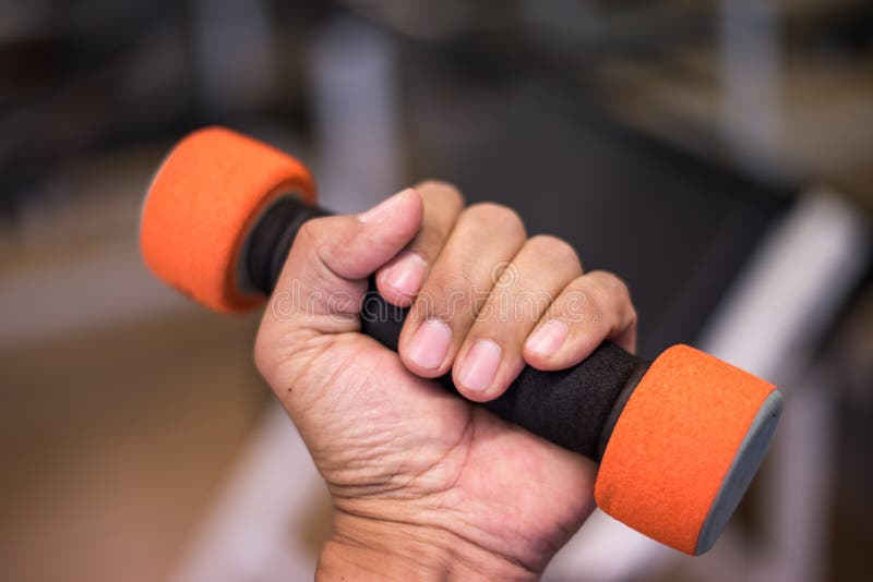 Hand holding dumbbell stock photo. Image of training - 81807712