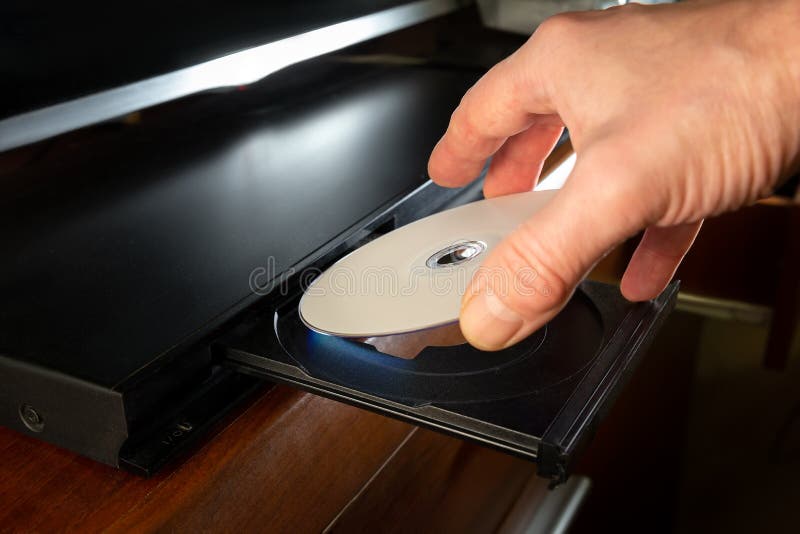 Hand Holding Dvd Insert To Dvd Player Stock Photo - Image of music ...