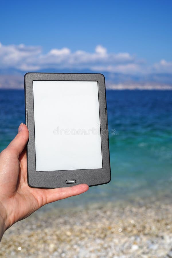 Hand Holding E-book Reader on the Beach Stock Photo - Image of display ...