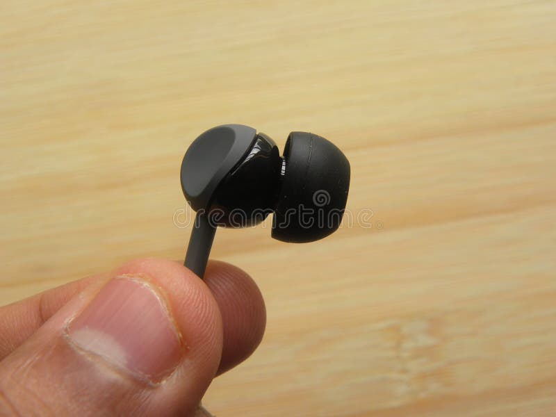 Hand Holding in-ear Headphone Stock Photo - Image of earpieces, buds ...
