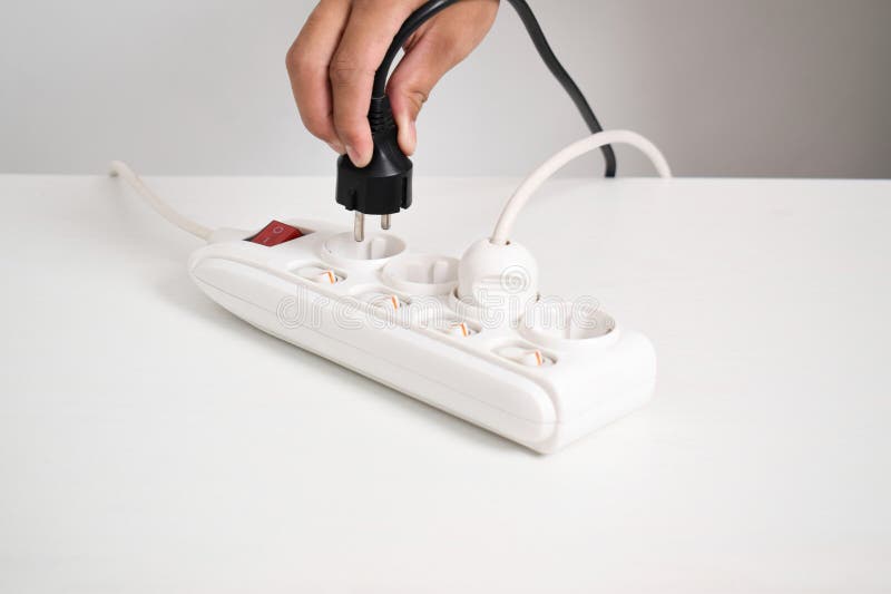Hand Holding Electric Plug, Multiple Socket with Connected Plugs. Stock ...