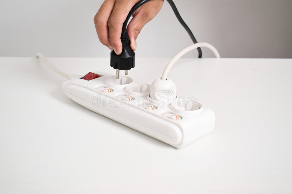 Hand Holding Electric Plug, Multiple Socket with Connected Plugs. Stock ...