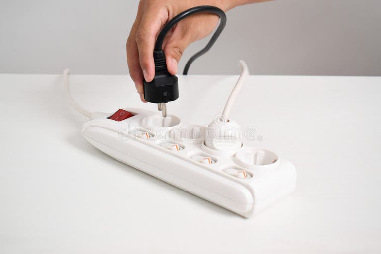 Hand Holding Electric Plug, Multiple Socket with Connected Plugs. Stock ...